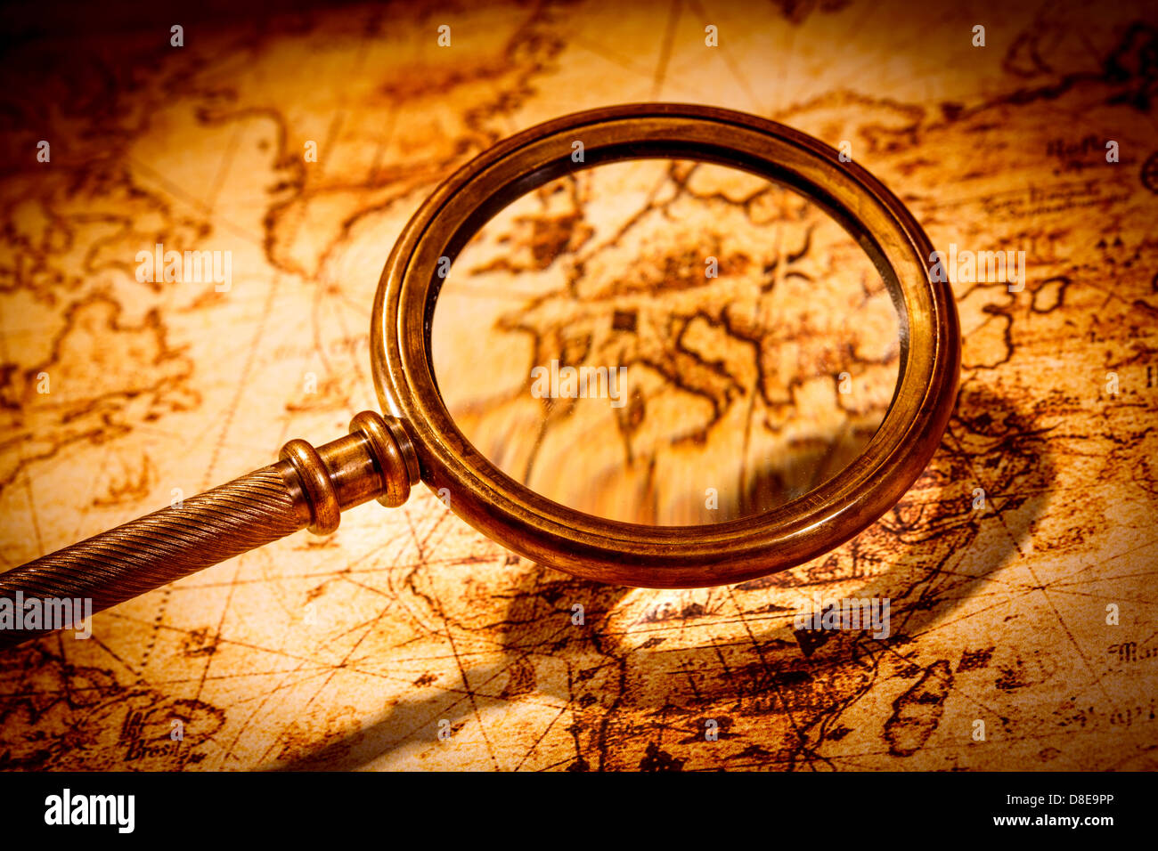 Vintage still life. Vintage magnifying glass lies on an ancient world ...