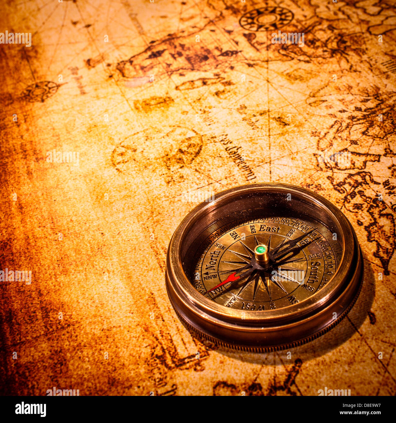 Vintage still life. Vintage compass lies on an ancient world map Stock ...