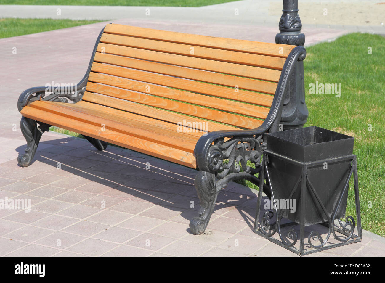 wooden bench with an urn Stock Photo - Alamy
