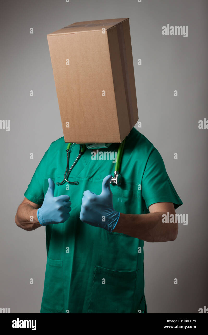 Doctor with cardboard box head in green uniform Stock Photo - Alamy