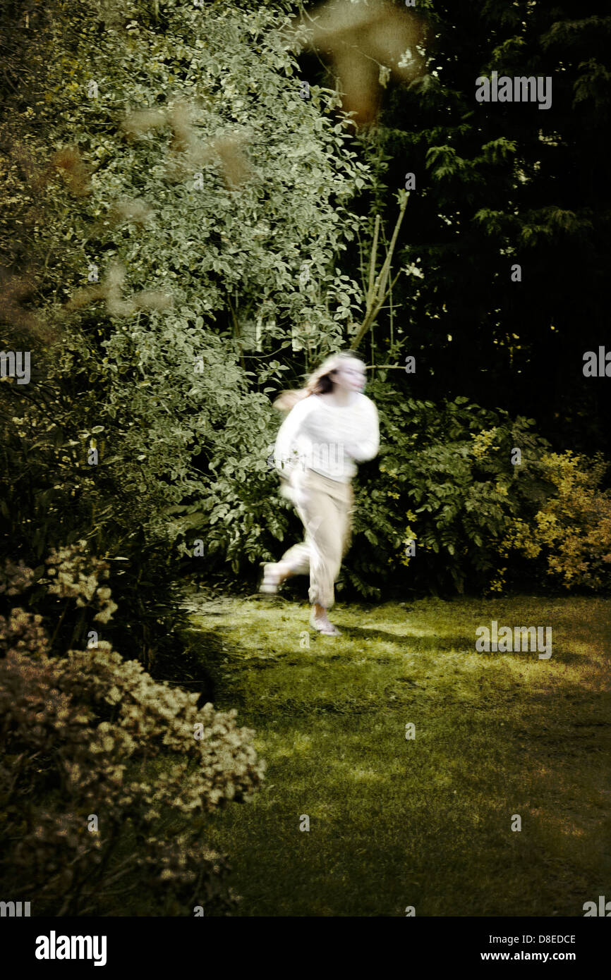 Woman Running through gardens Stock Photo - Alamy