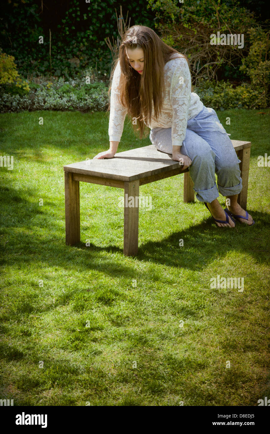 Woman Sitting on Garden Bench Stock Photo - Alamy