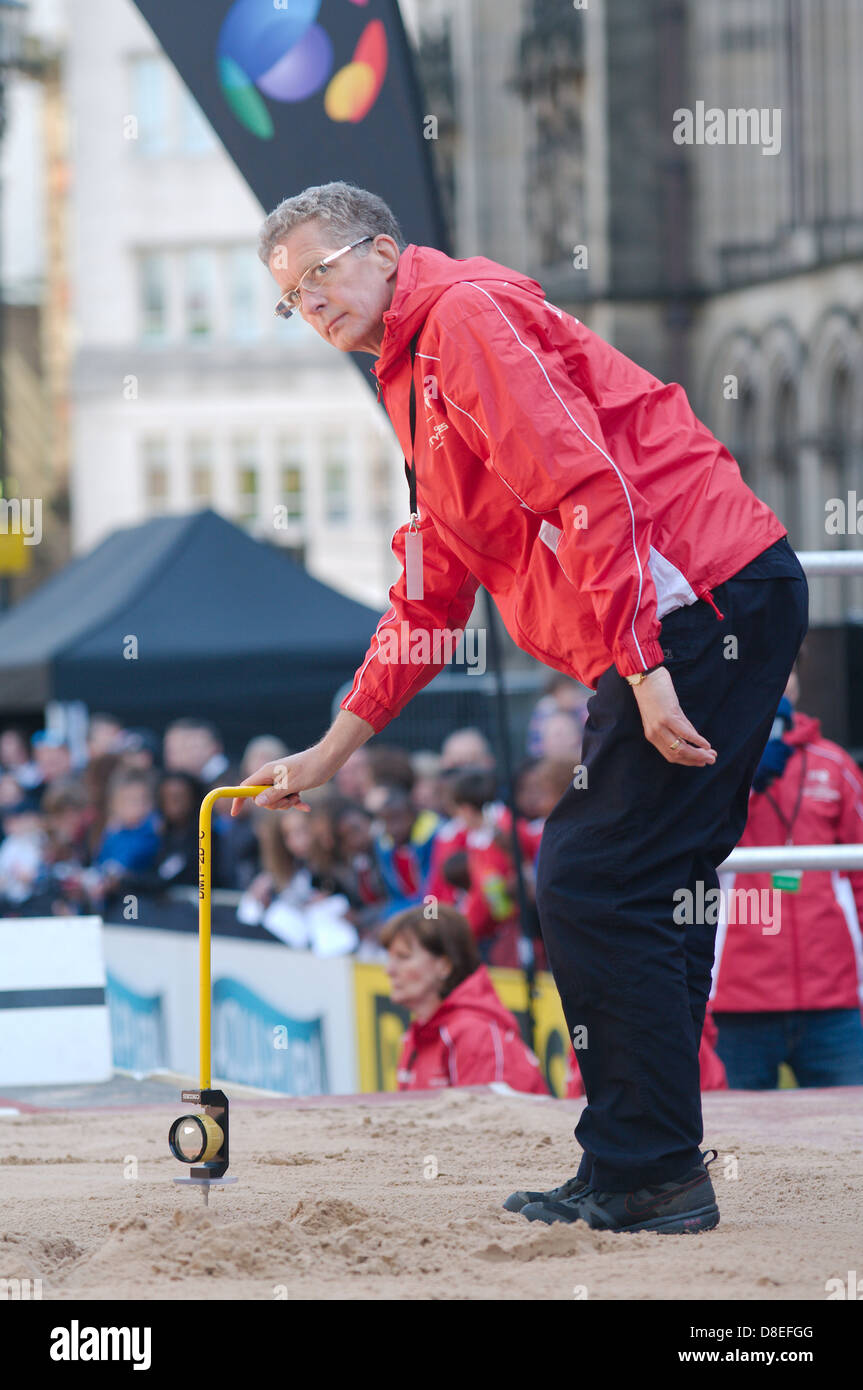 An official holding the measure at the long jump during the BT Great ...