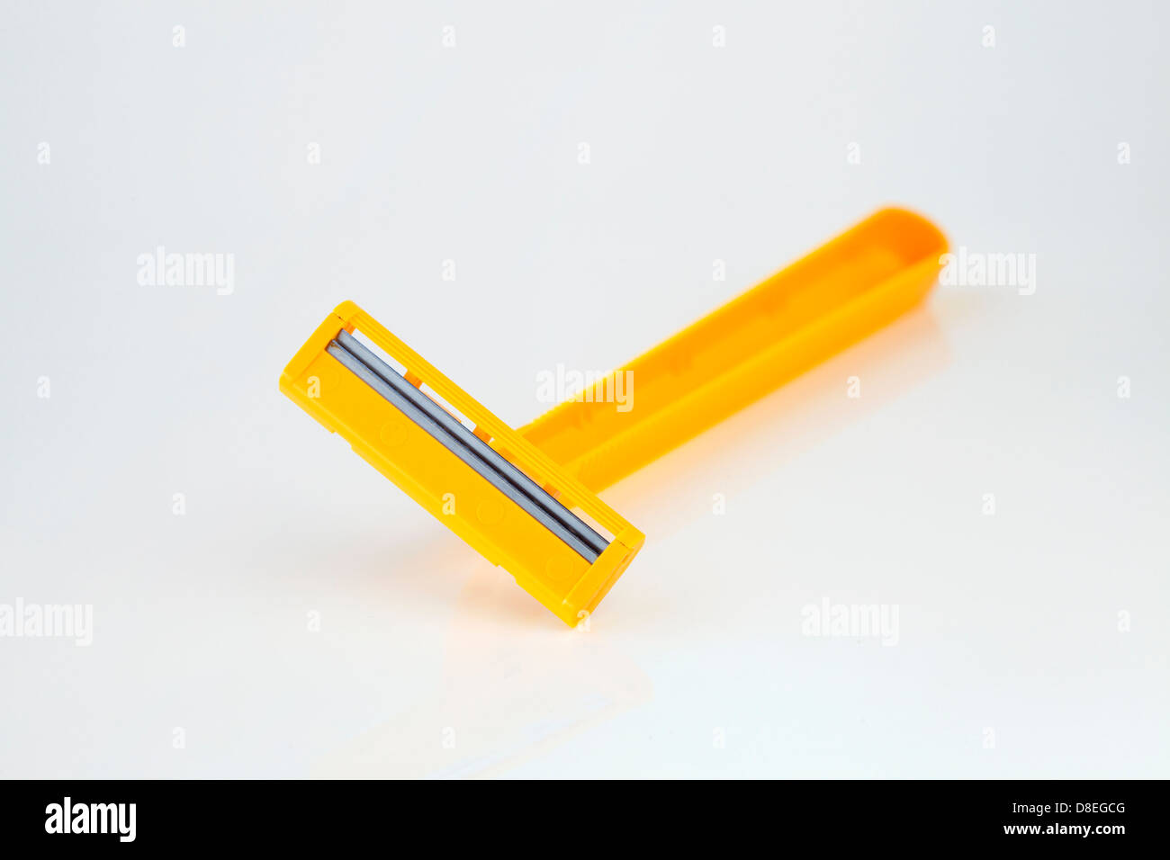 Image of yellow razor placed on white background Stock Photo - Alamy
