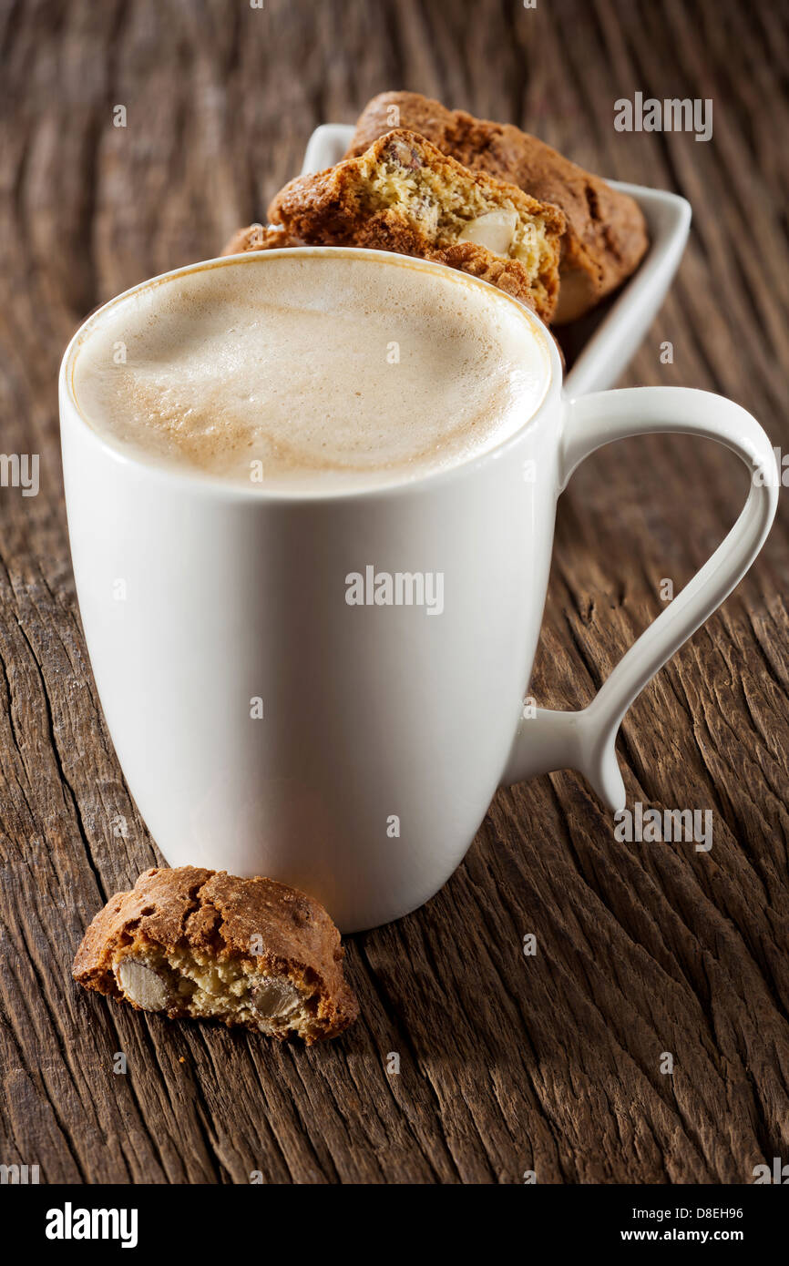 A cup of cappuccino and Cantuccini fine pastry on a wooden background ...