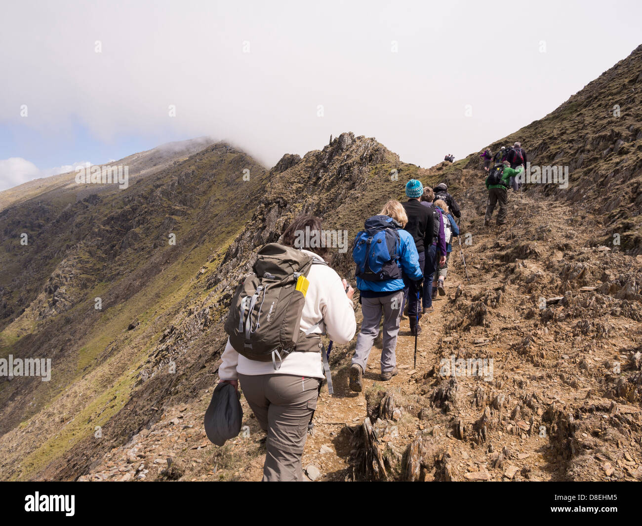 Ramblers walking on Rhyd Ddu path on Bwlch Main to Snowdon with view of ...