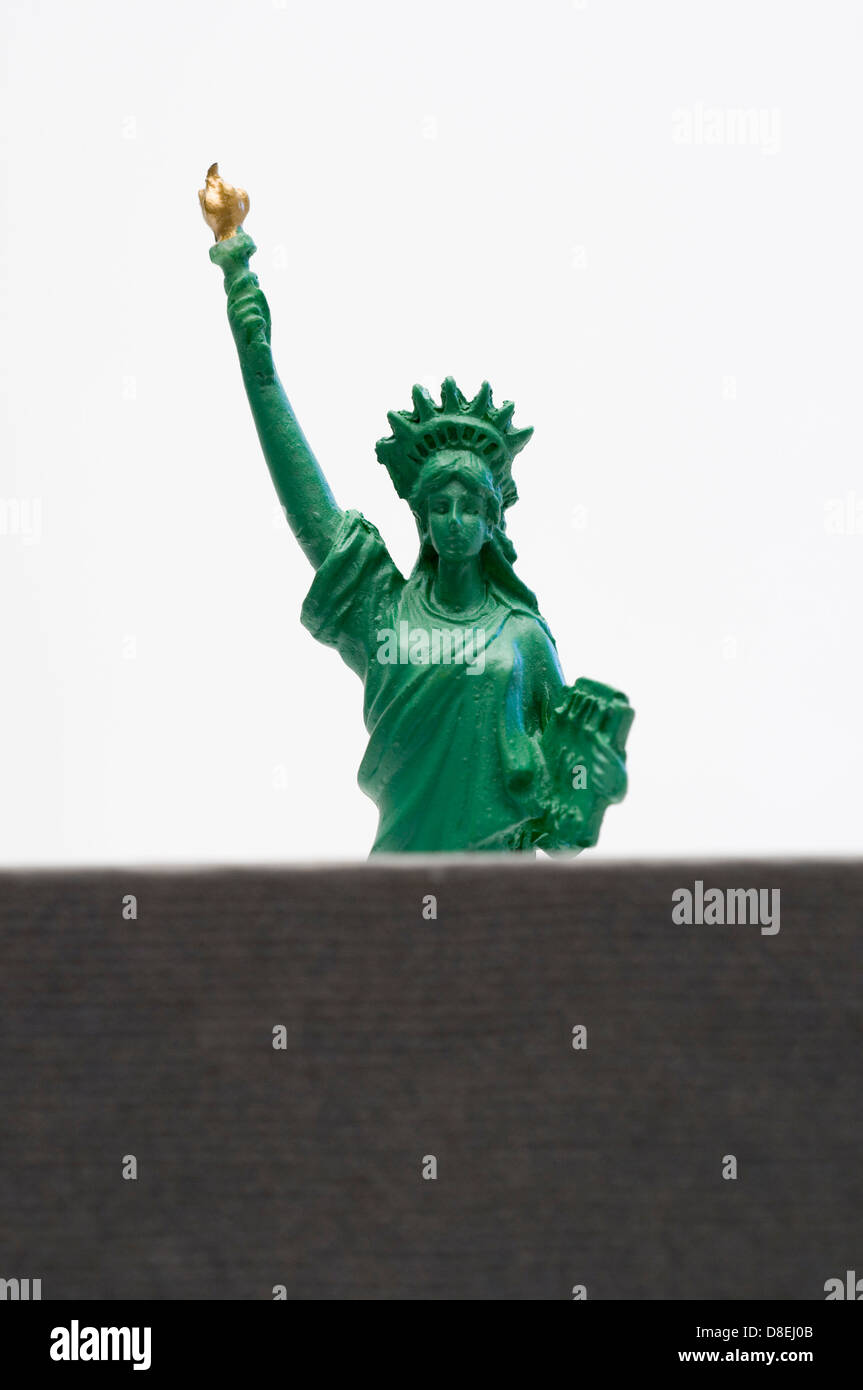 Statue of Liberty miniature behind a wall Stock Photo - Alamy