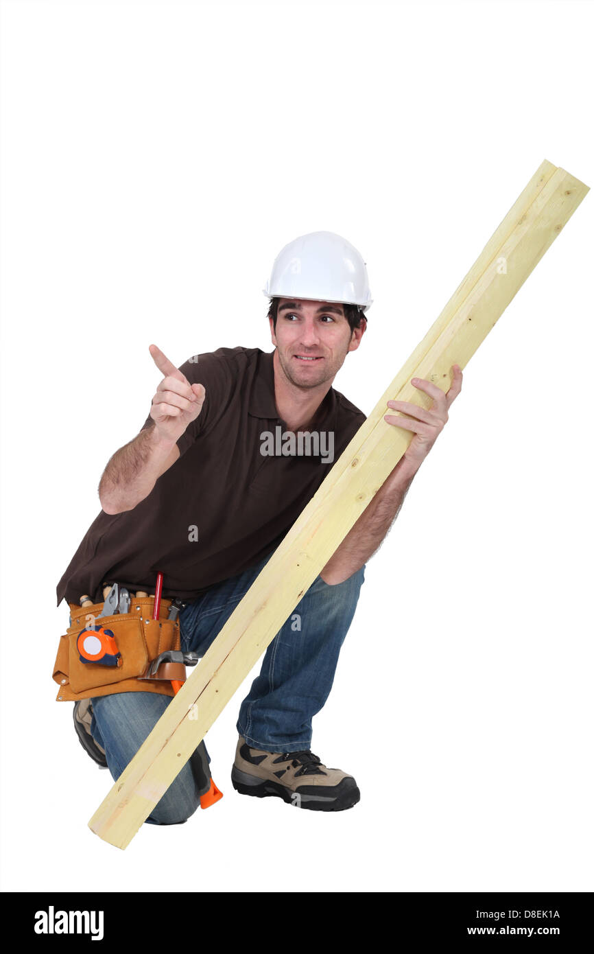 Male carpenter showing direction Stock Photo - Alamy