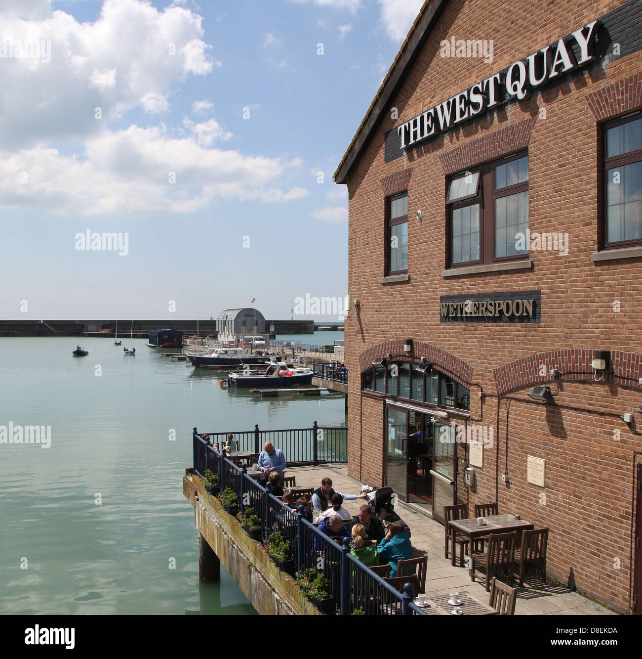 People dining outside a Wetherspoon restaurant at Brighton Marina Stock ...
