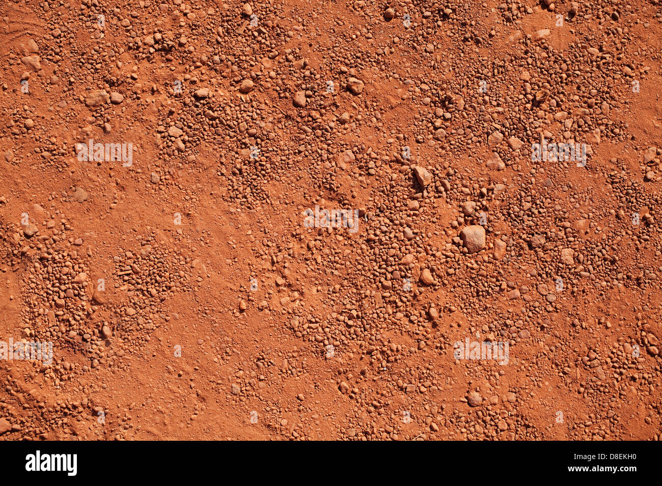 Texture of dry red clay with stones close-up Stock Photo - Alamy