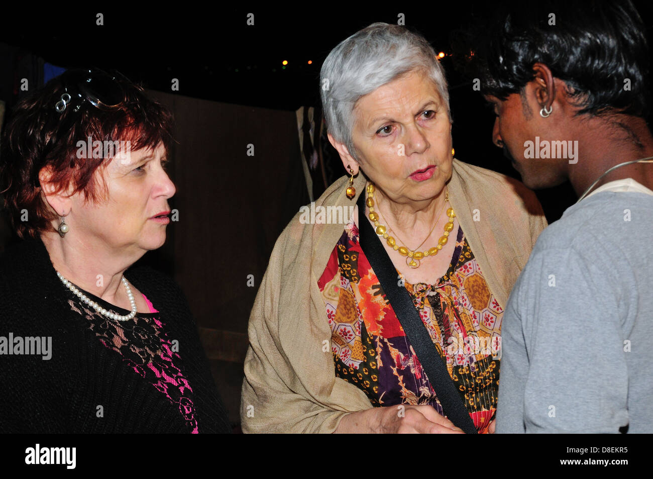 Italian women talking with Indian man at the party Stock Photo - Alamy