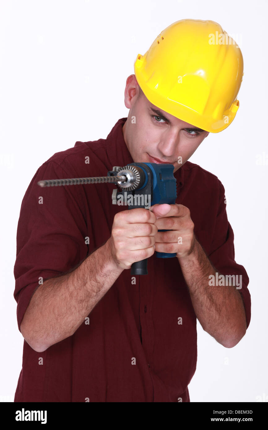 Man aiming power drill Stock Photo - Alamy