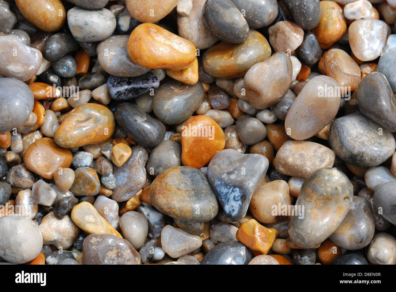 Pebbles on a beach being washed by the waves england uk Stock Photo - Alamy