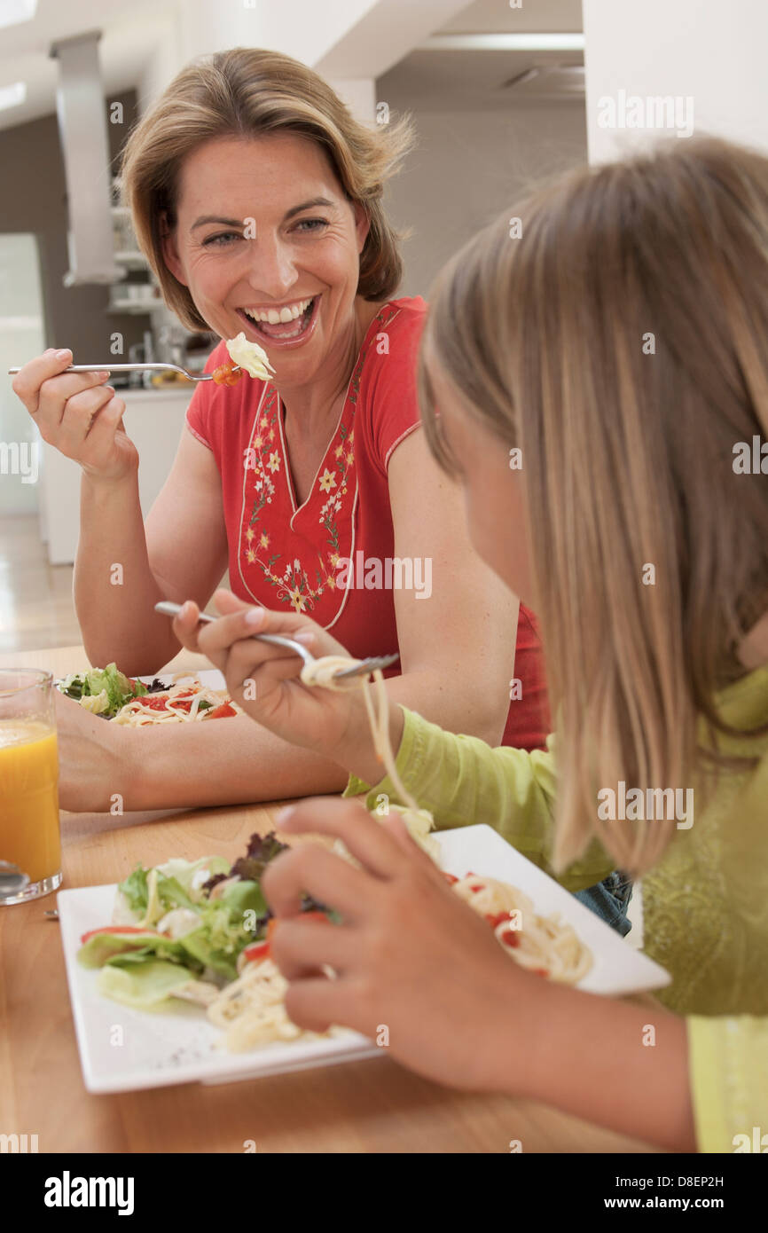 Mother and daughter eating together Stock Photo - Alamy