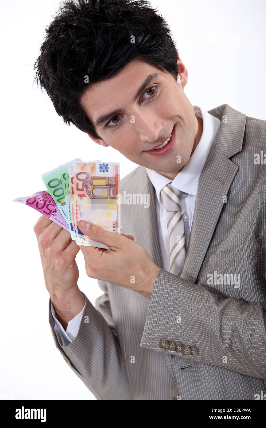 Businessman holding bank notes Stock Photo - Alamy