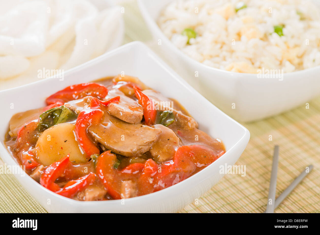 Chinese style pork with red peppers served with egg fried rice Stock ...