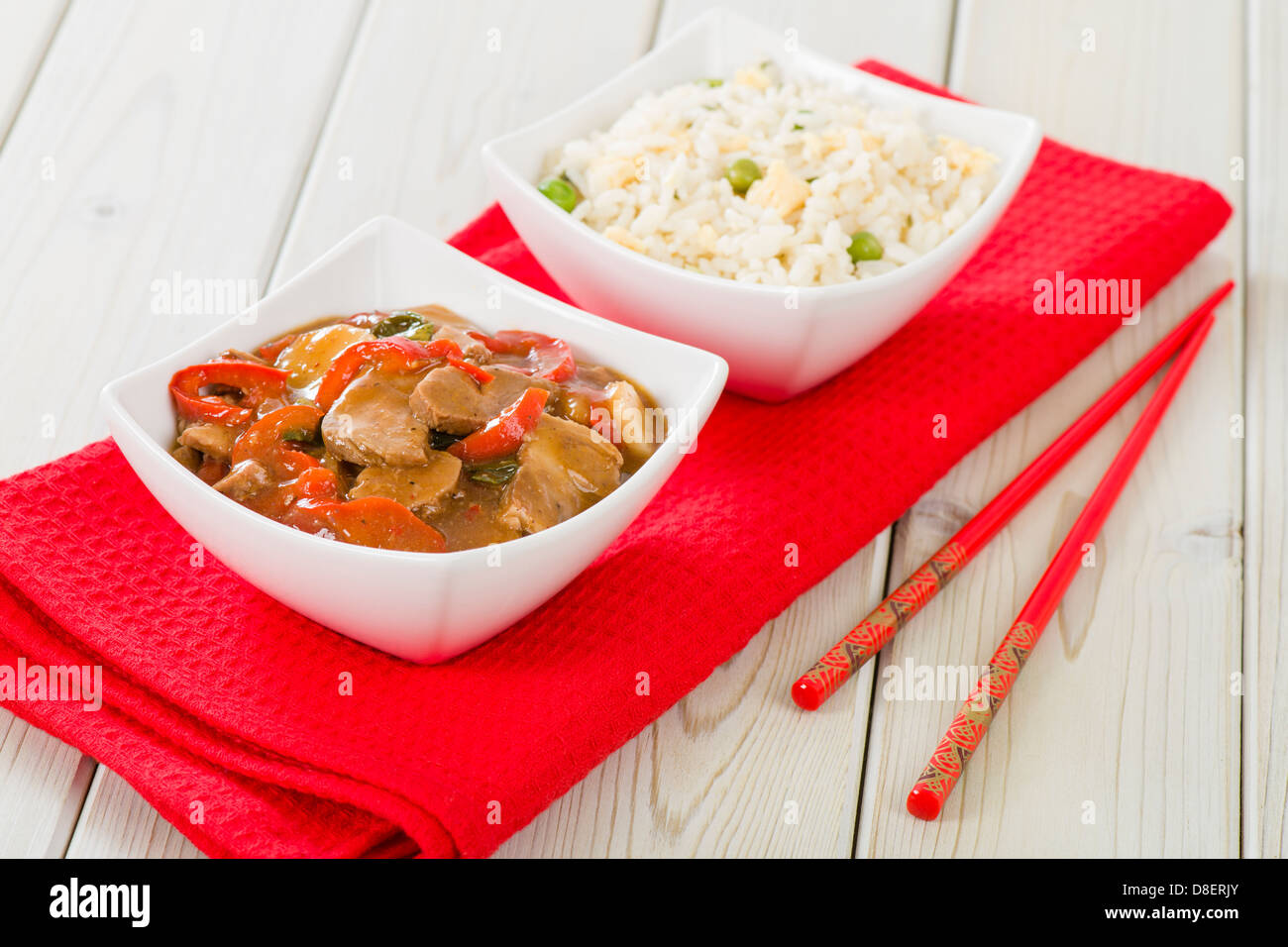 Chinese style pork with red peppers served with egg fried rice Stock ...