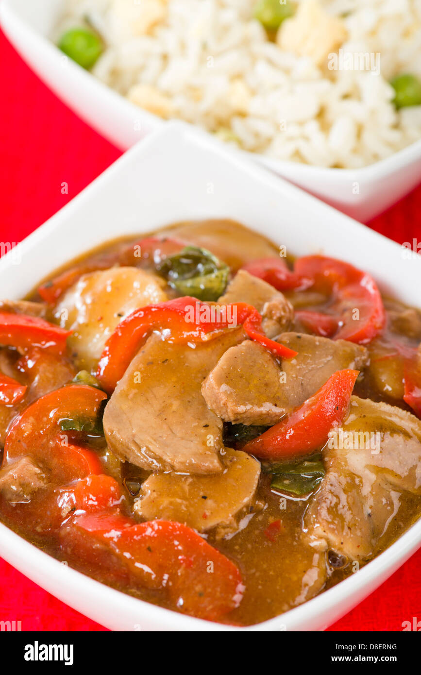 Chinese style pork with red peppers served with egg fried rice Stock ...