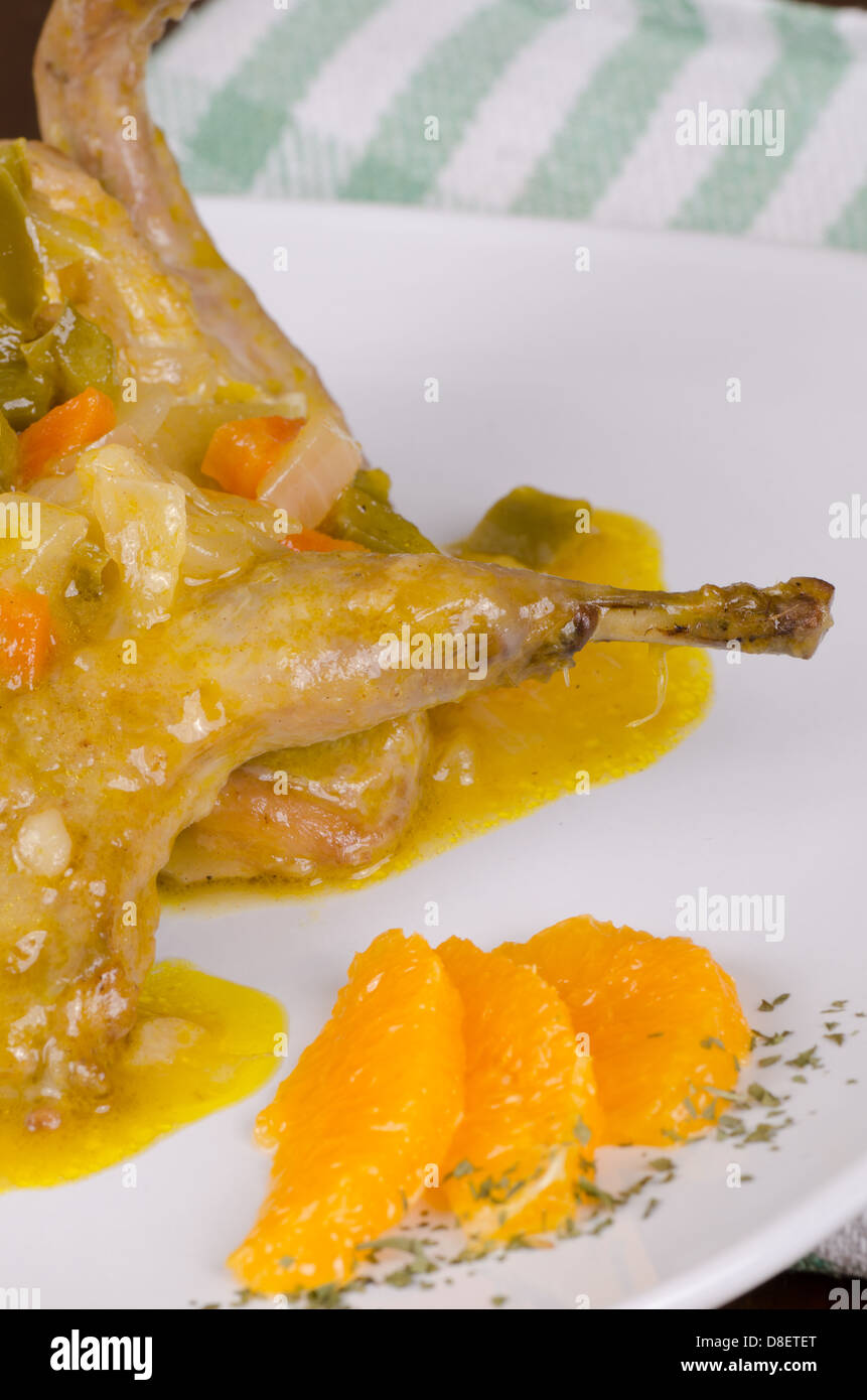Detail take of quail served in orange sauce Stock Photo - Alamy