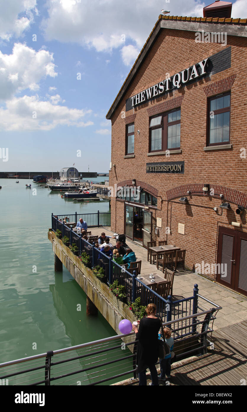 People dining outside a Wetherspoon restaurant at Brighton Marina Stock ...