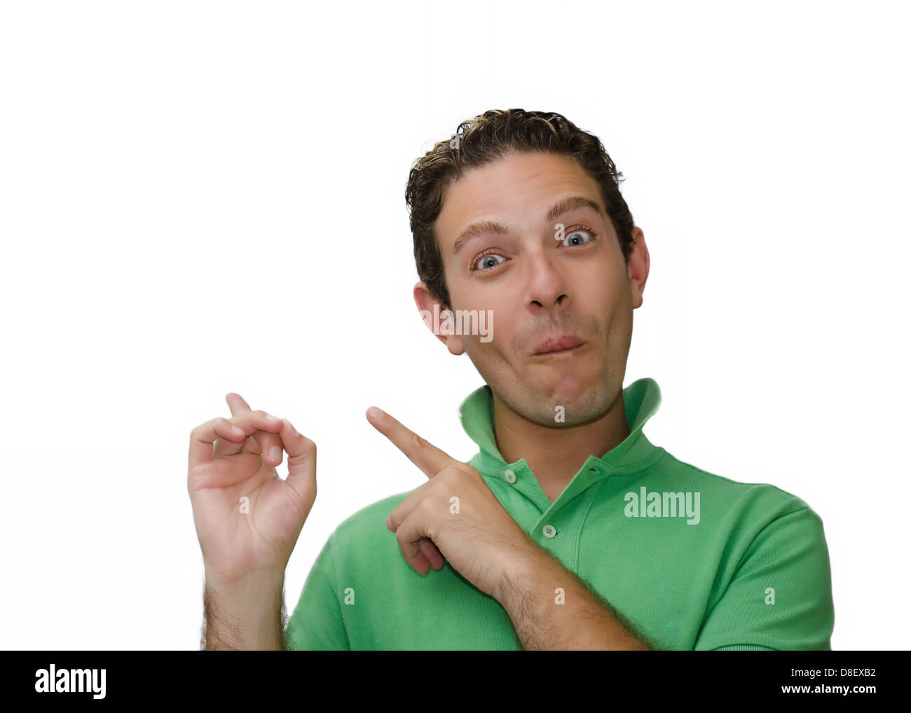 Attractive young man with silly and funny face pointing fingers to ...