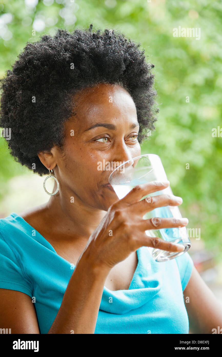 Woman drinking glass of water Stock Photo - Alamy