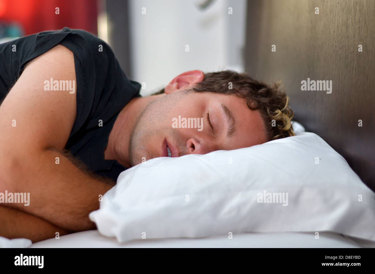 Handsome young man sleeping on white pillow Stock Photo - Alamy