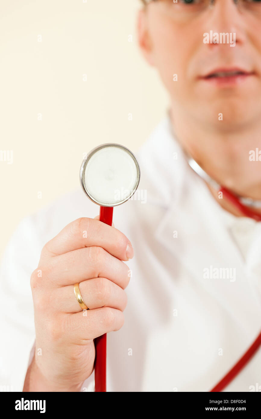 Medical doctor with stethoscope, focus is on the worktool Stock Photo ...