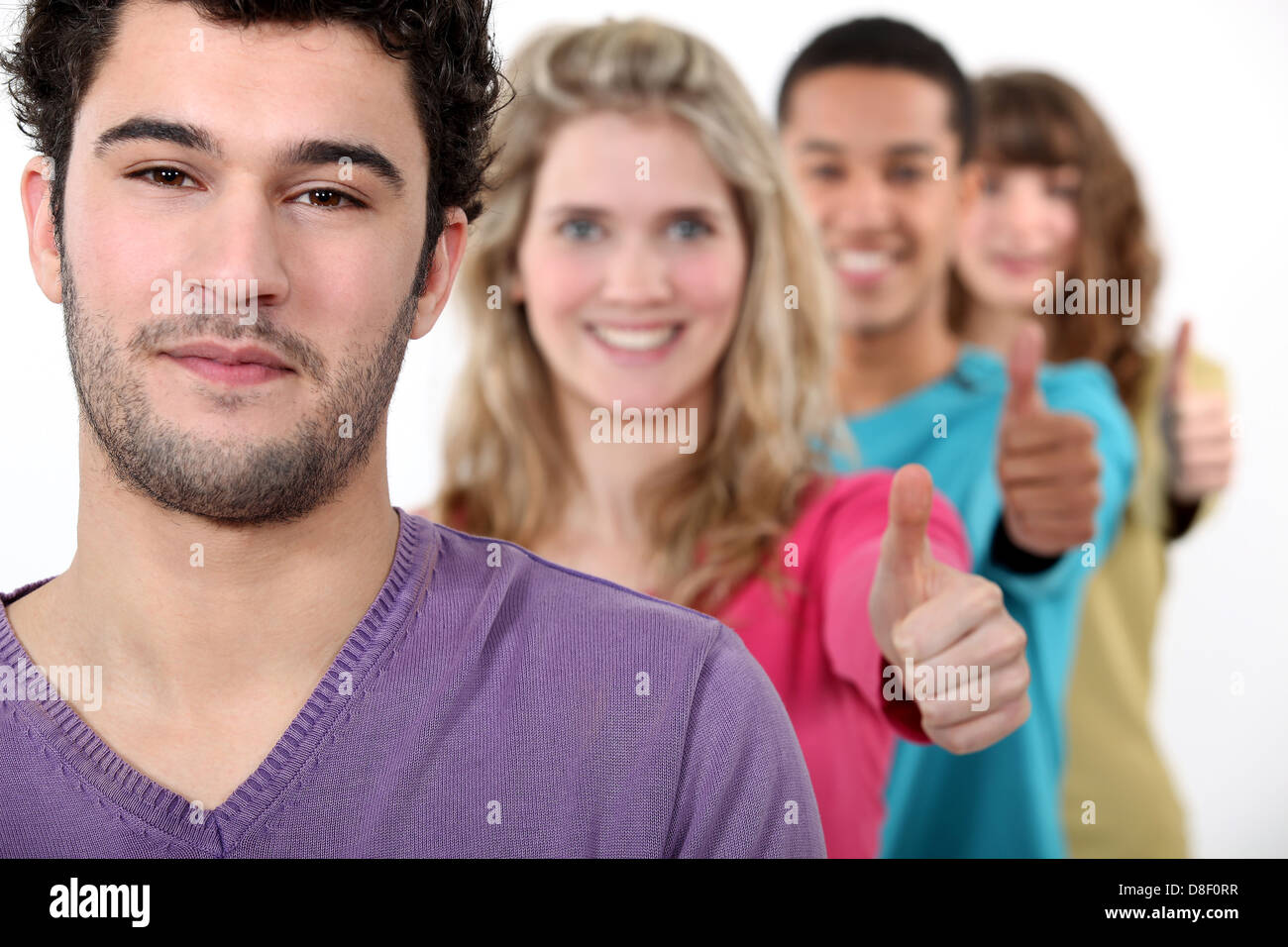 Young group of people giving the thumb's up Stock Photo - Alamy