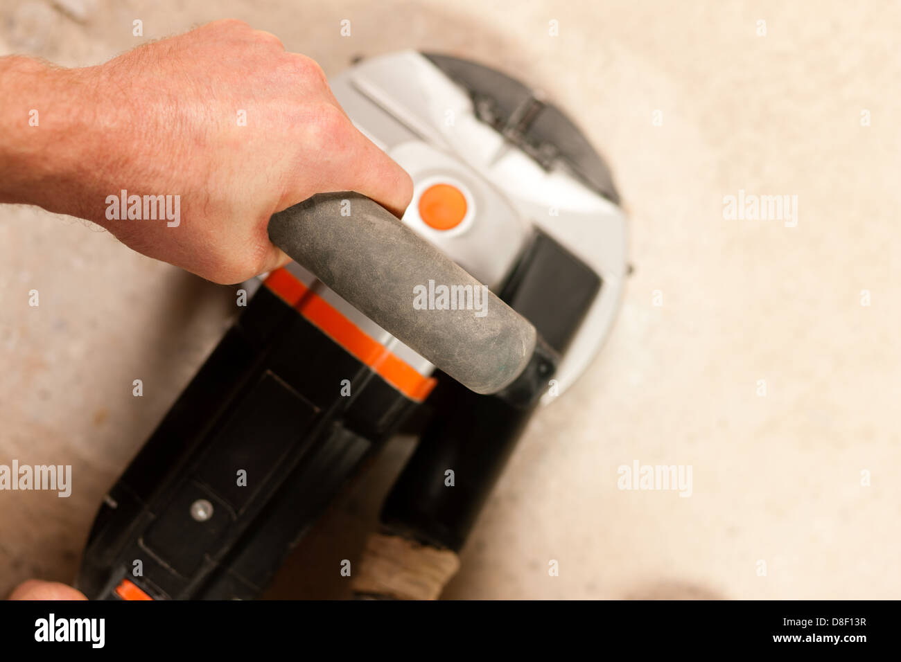 Construction worker working grinding the cement floor (only hand and ...