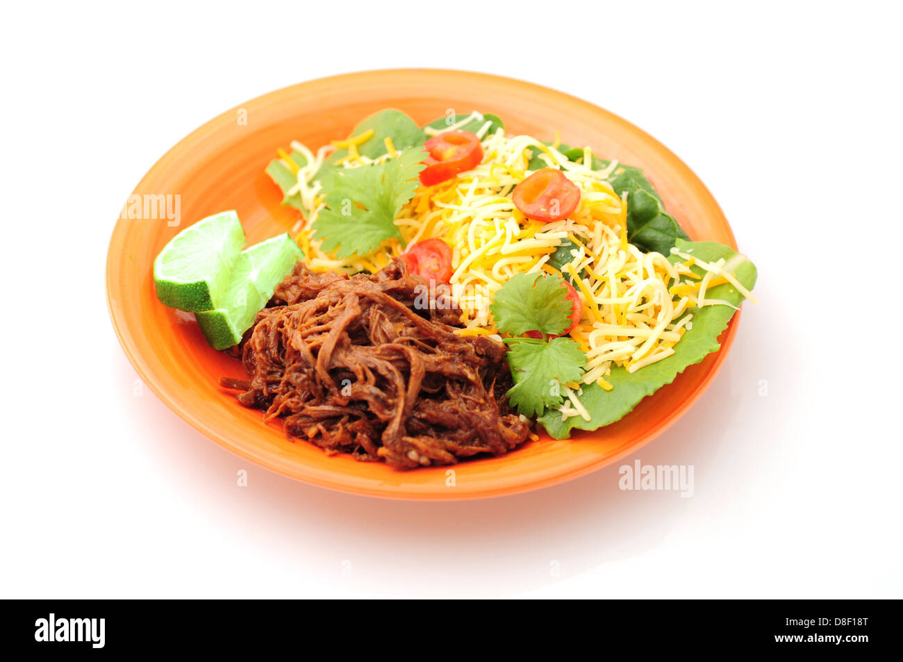 Orange plate of shredded beef with limes and a healthy salad Stock ...