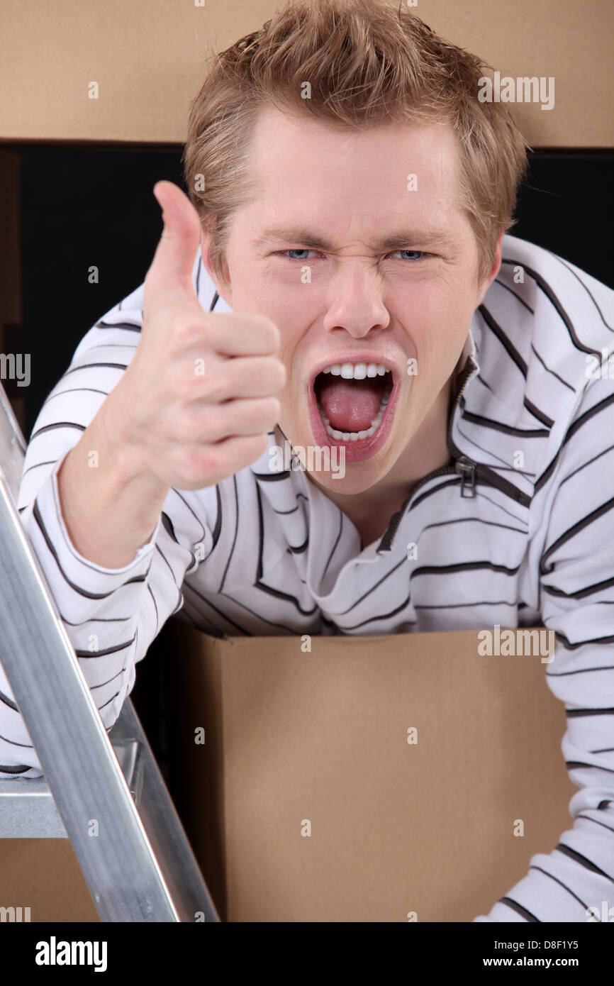 Thumbs up from a man with cardboard boxes Stock Photo - Alamy