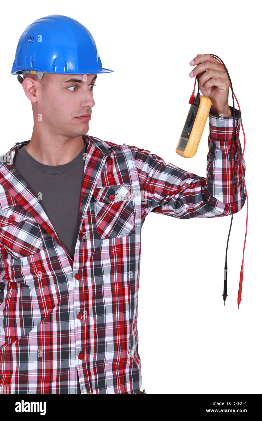 Electrician holding multimeter Stock Photo - Alamy