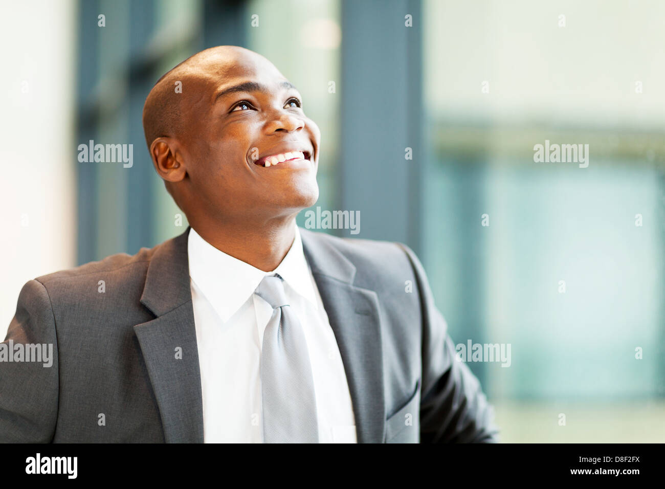 optimistic african american businessman looking up Stock Photo - Alamy