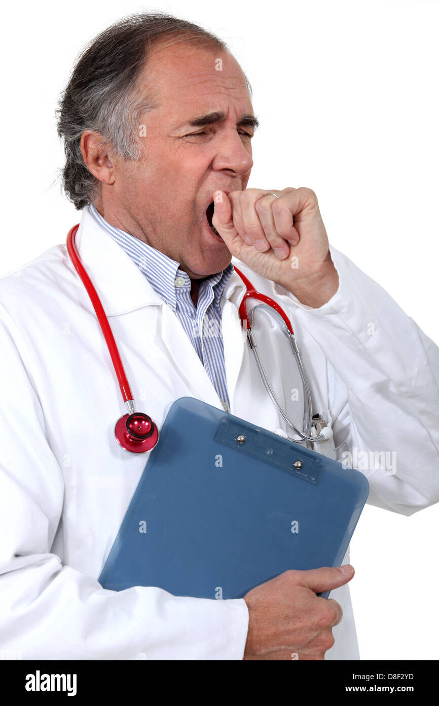 Tired doctor yawning Stock Photo - Alamy