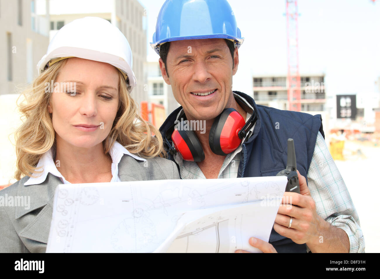 Architect and builder on site with plans Stock Photo - Alamy