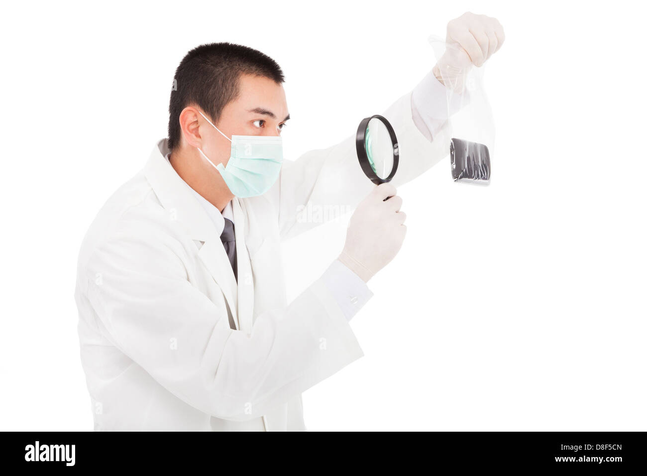 young investigator watching the evidence by magnifier Stock Photo - Alamy