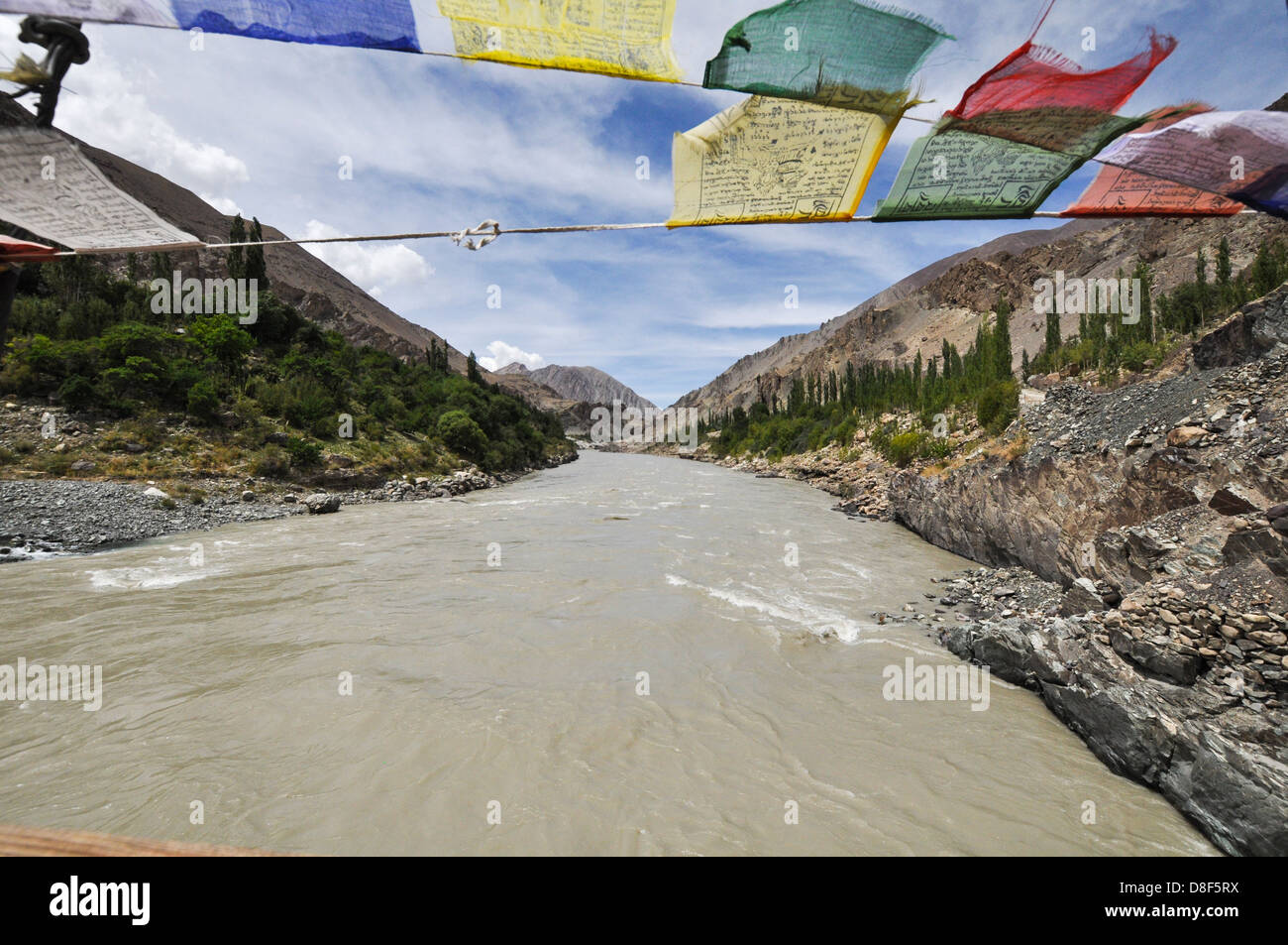 A view of the Indus River with prayer flags at Leh, Ladakh, Jammu and ...
