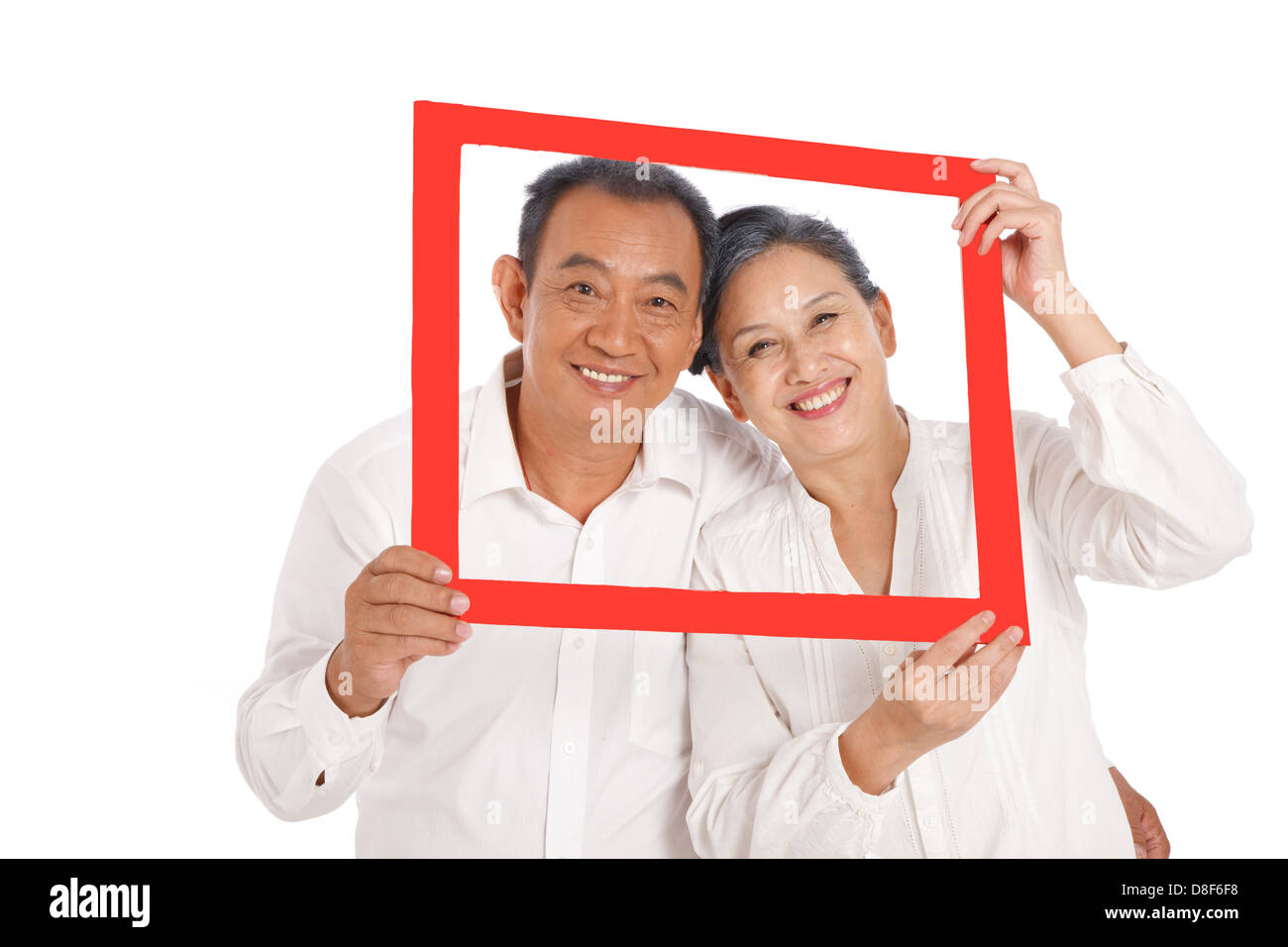 Old couple holding photo frame Stock Photo - Alamy