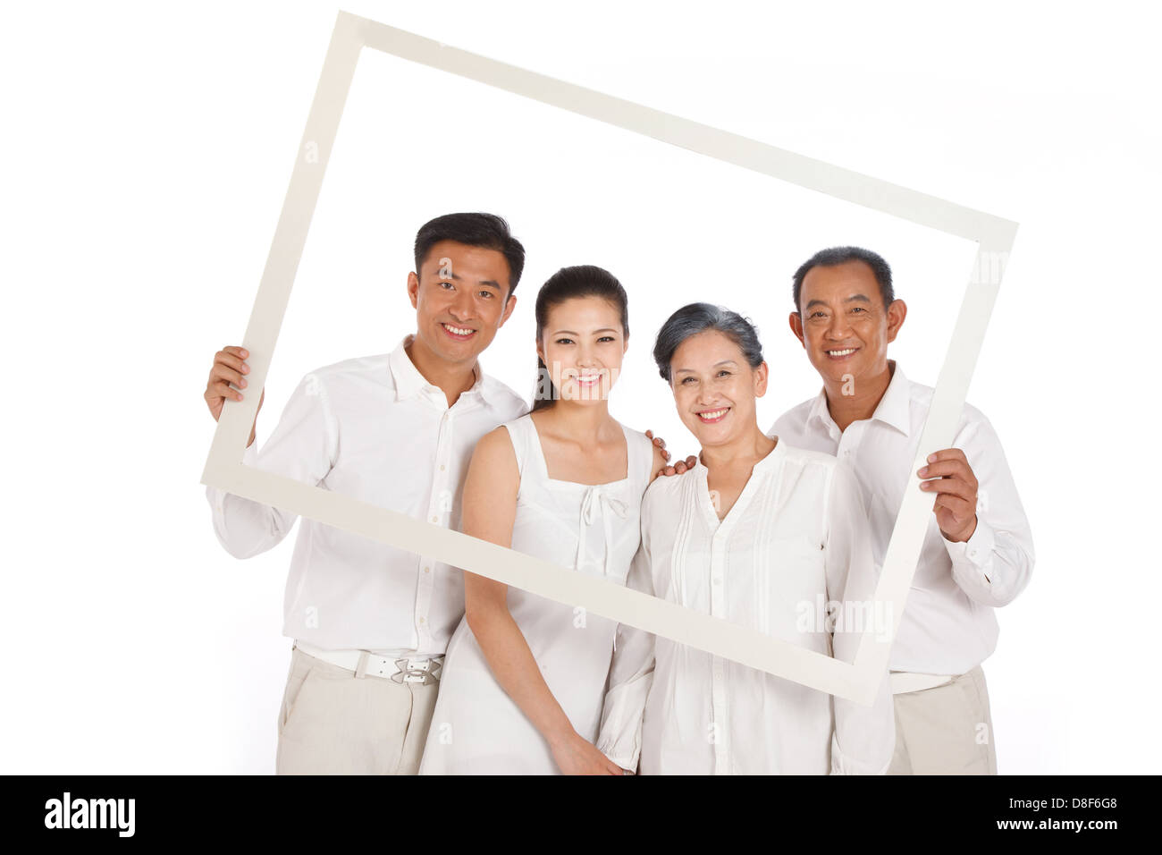 Whole family holding photo frame Stock Photo - Alamy