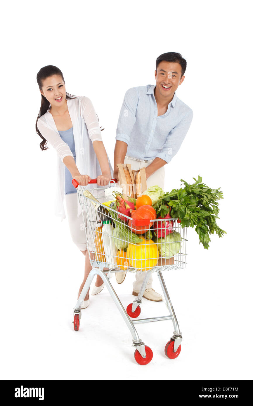 Young couple shopping with shopping cart Stock Photo - Alamy