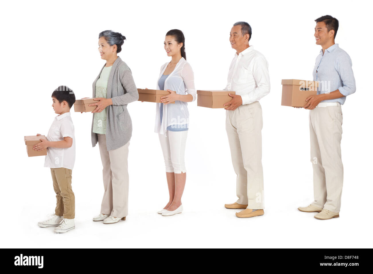 Whole family holding boxes Stock Photo - Alamy