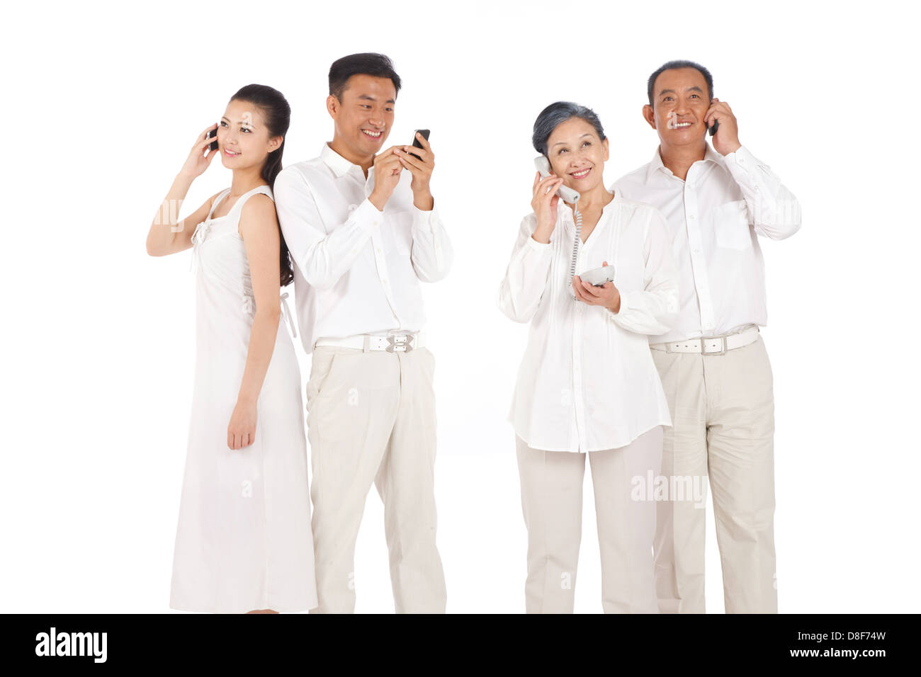 Old couple and young couple making phone call Stock Photo - Alamy