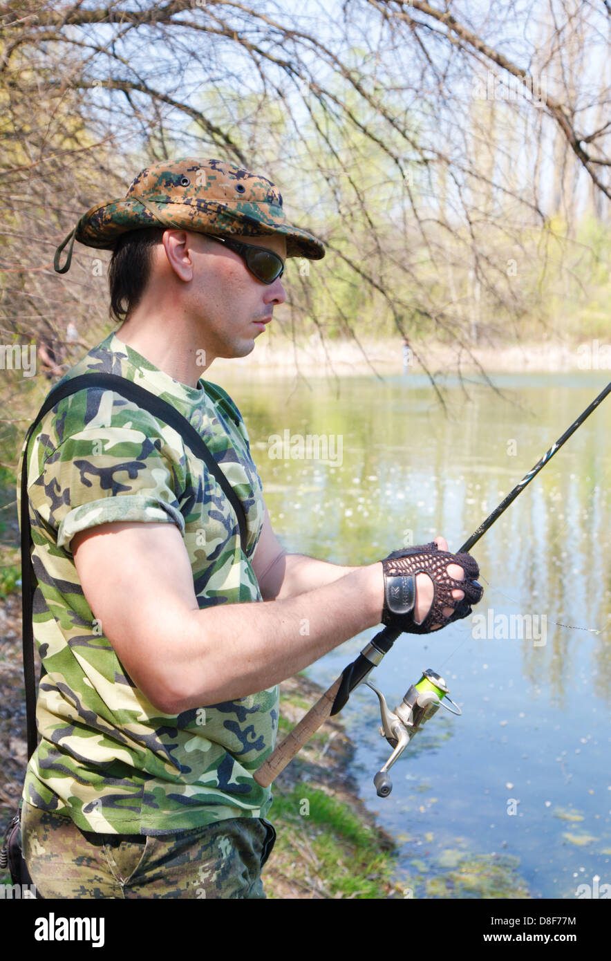 Young man fishing Stock Photo - Alamy