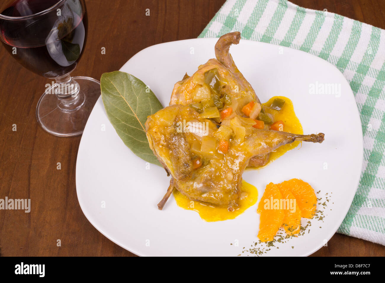 Portion of roast quail in orange sauce from a high angle viewpoint ...