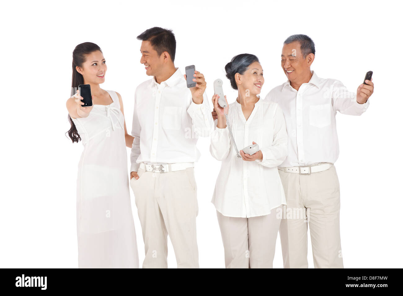 Old couple and young couple making phone call Stock Photo - Alamy