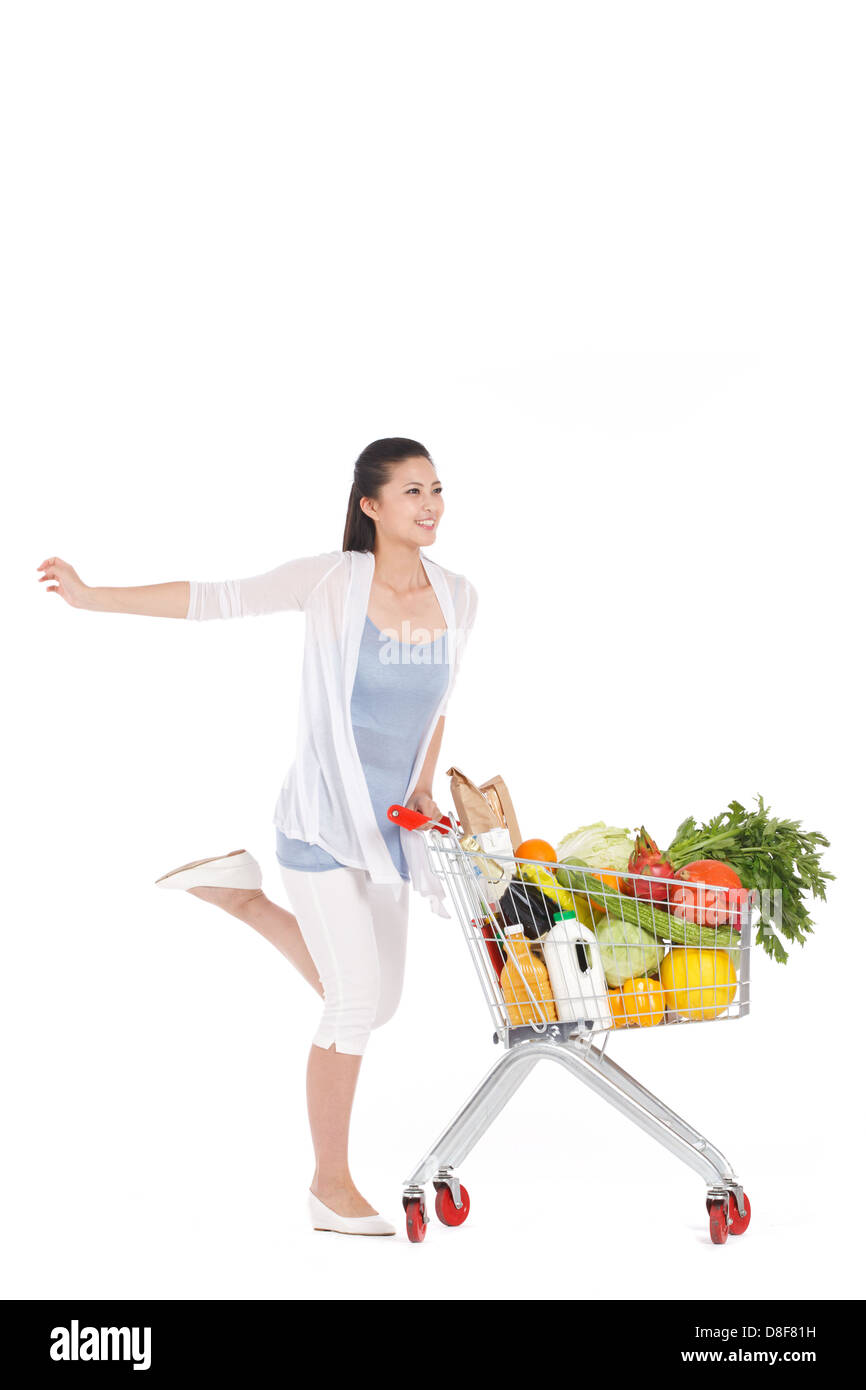 Young woman shopping with shopping cart Stock Photo - Alamy