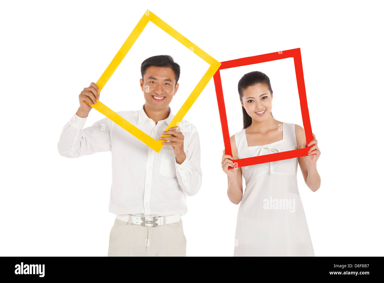Young couple holding photo frame Stock Photo - Alamy
