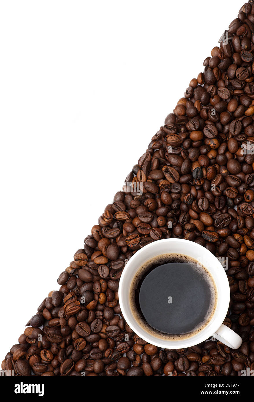 Coffee beans background with a cup of coffee Stock Photo - Alamy