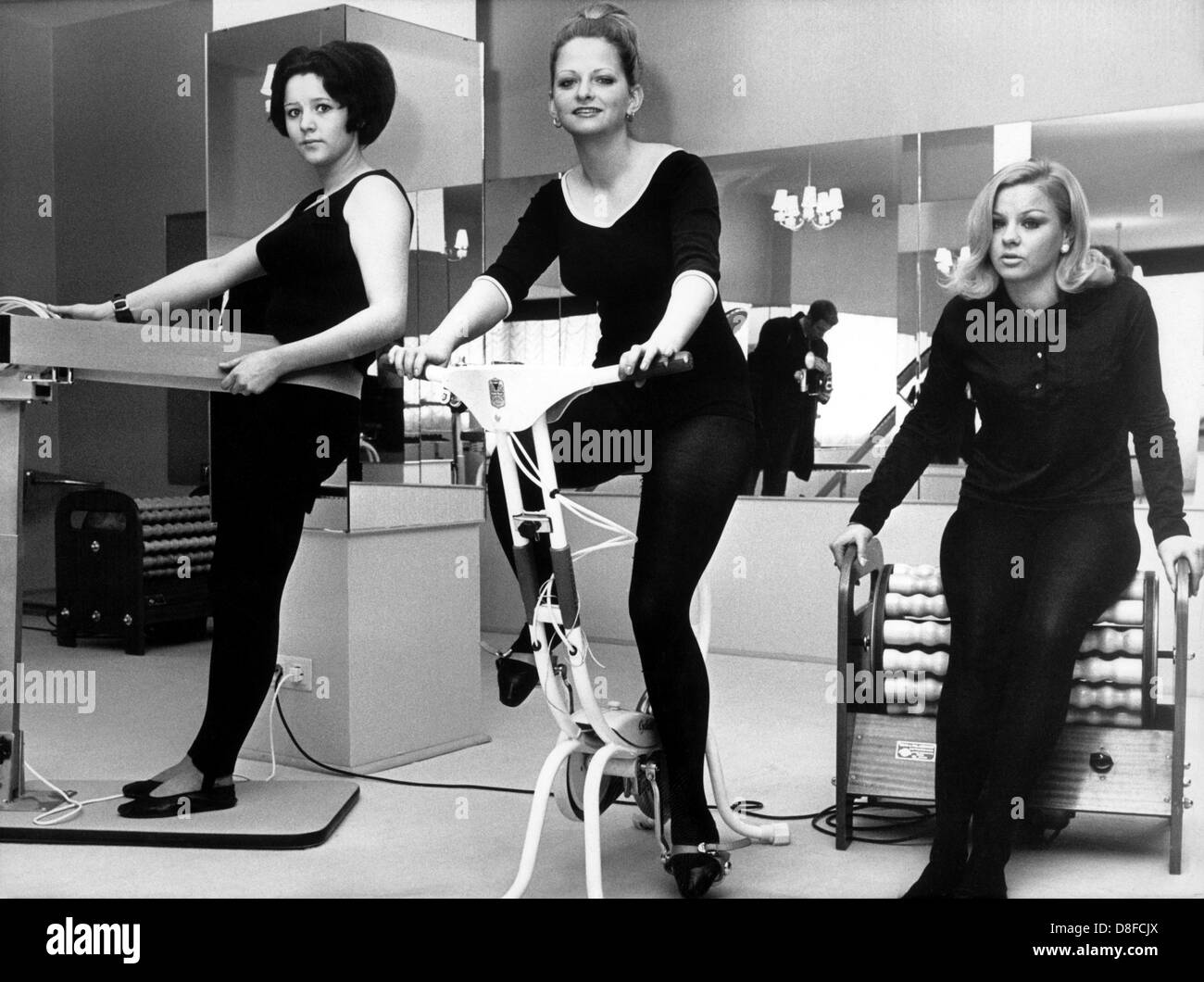 Three young women do their exercise in a recently opened fitness studio ...
